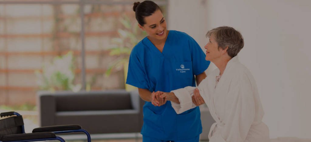 VHC Slider Helping Client Stand | Valley Home Care | Senior Caregivers